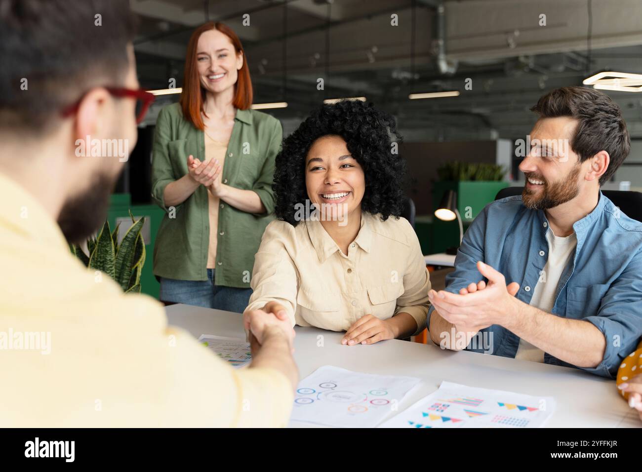Happy diverse business team applauding congratulating black female ...