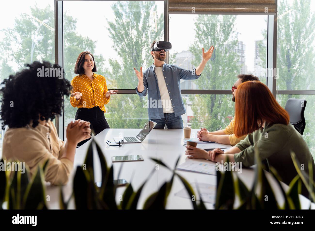 Business colleagues enjoying a vr experience during a meeting in a ...