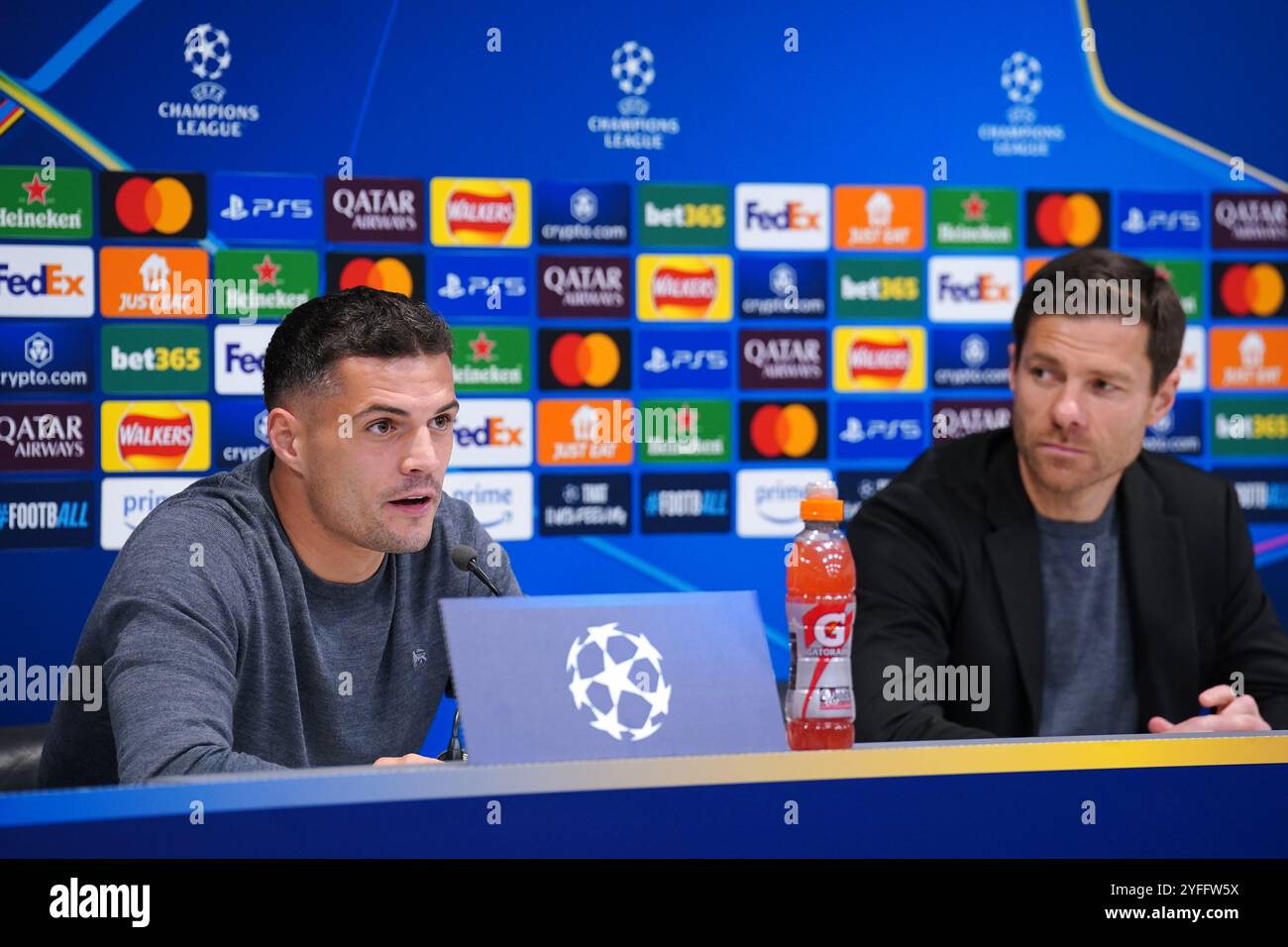 Bayer Leverkusen's Granit Xhaka (left) with manager Xabi Alonso during ...