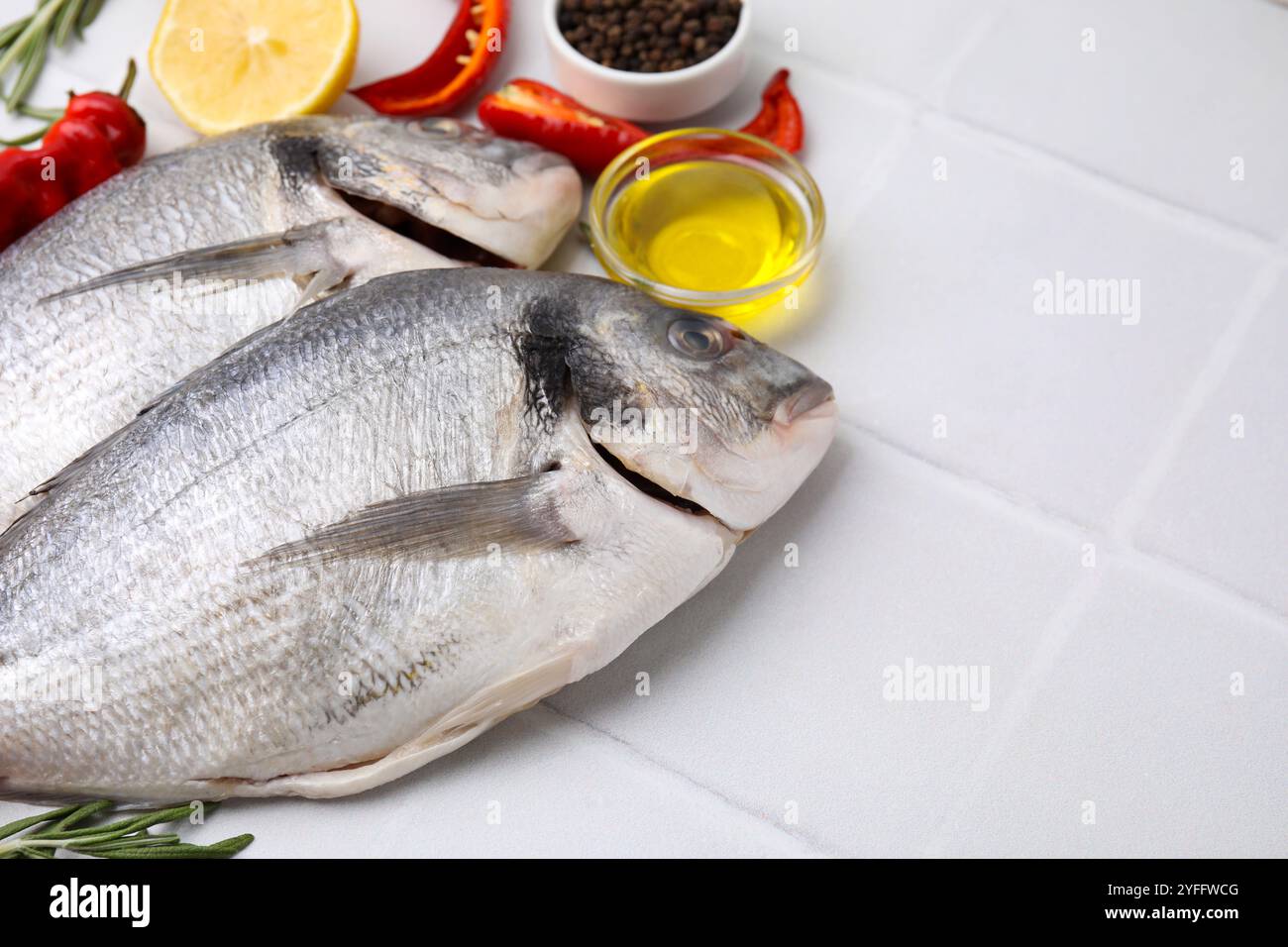 Sea food. Fresh raw fish and products on white tiled table, closeup ...