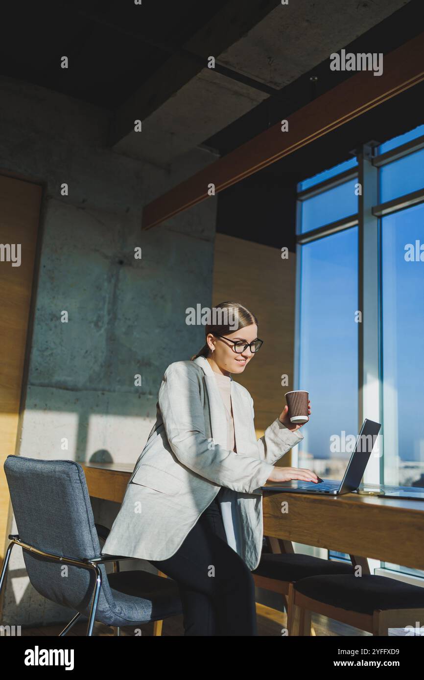 Office work, attractive young female manager working in office ...