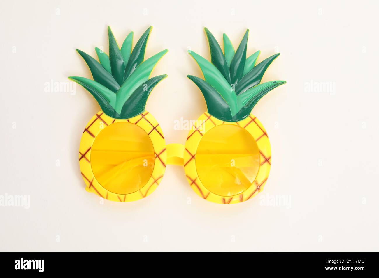Creative pineapple shaped sunglasses on white background, top view ...