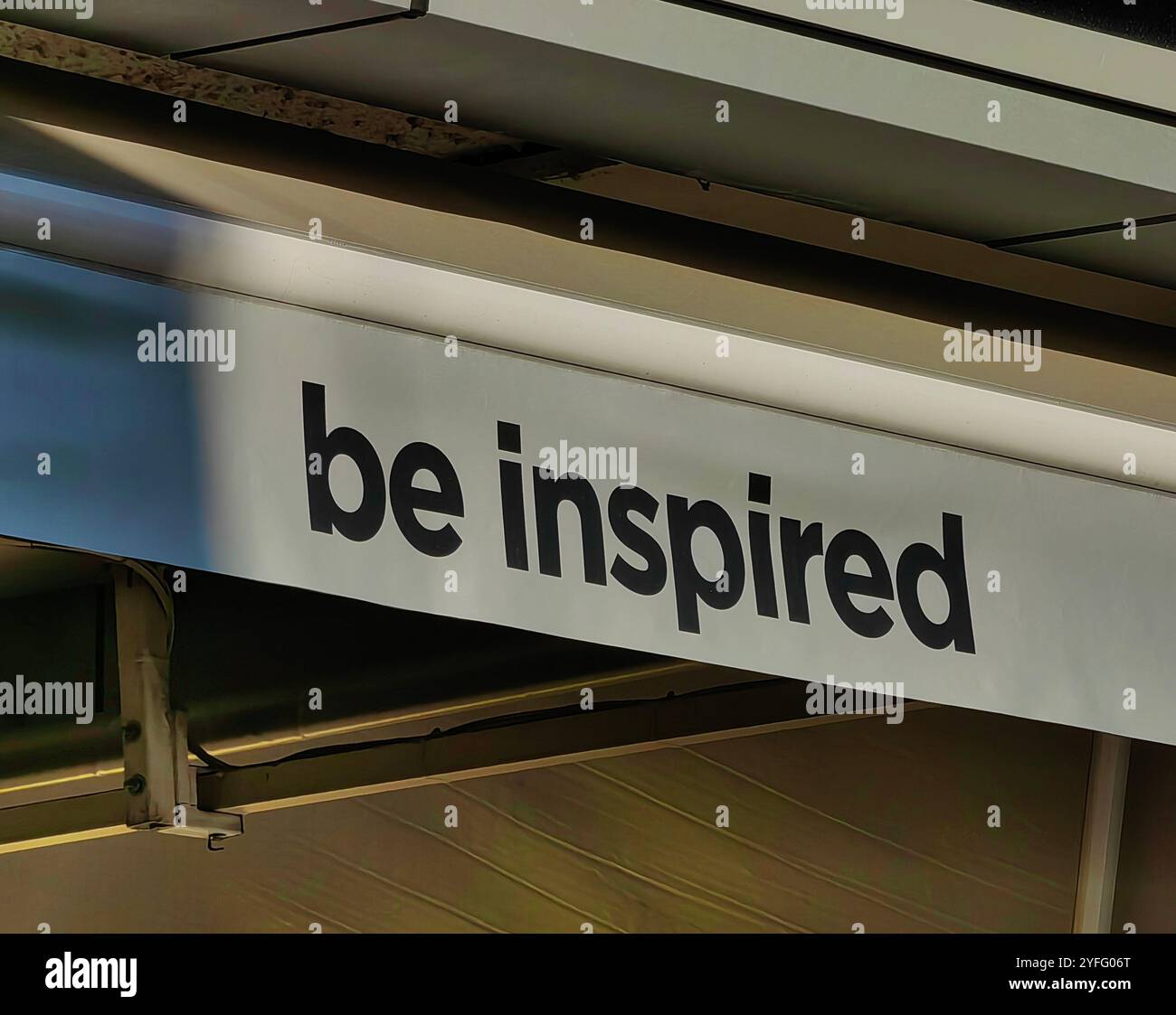 Be Inspired: Bold Message in Black Letters on White Awning Construction ...