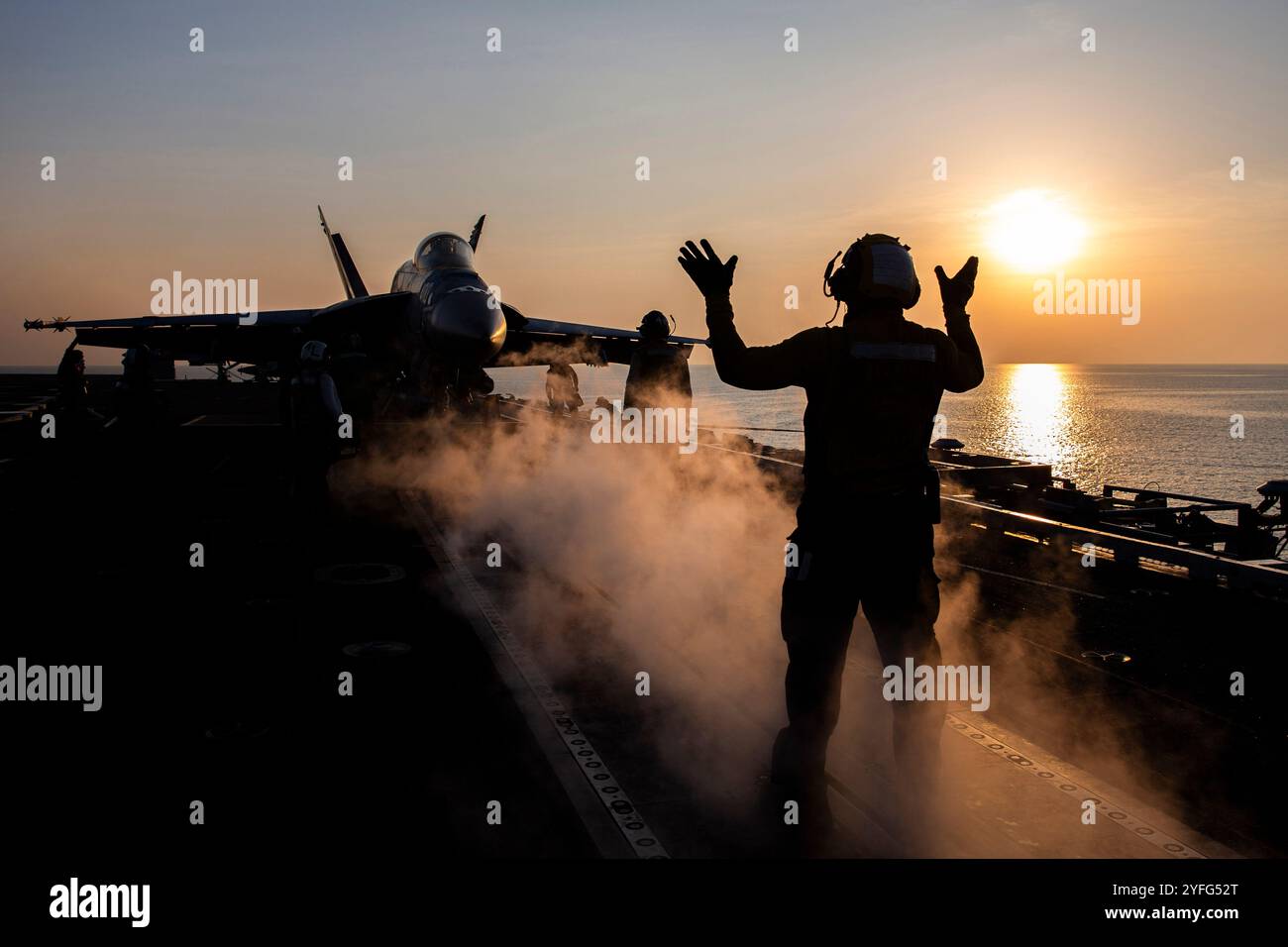 At Sea. 25th Oct, 2024. A U.S. Navy Aviation Boatswains Mate (Handling) directs an F/A-18E Super ...