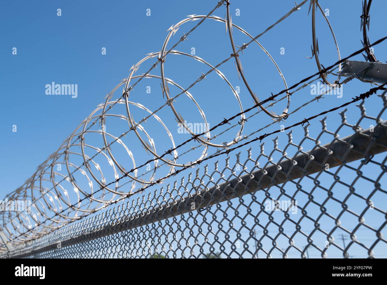 Barbed wire on the fence. Barbed wire fence delimiting the border of ...