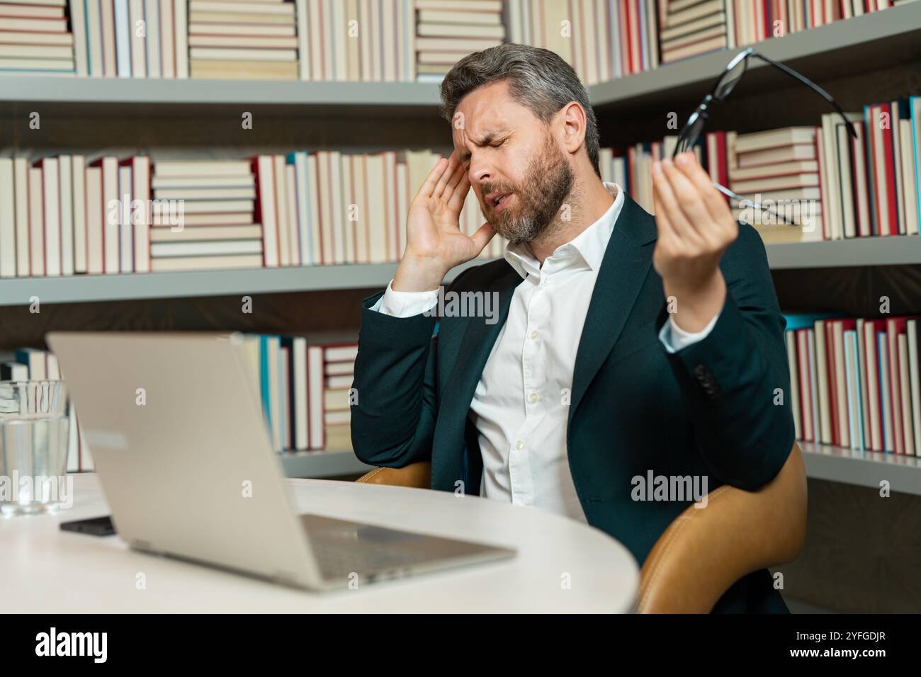 Tired, headache and eye strain on laptop. Man with stress, burnout and ...