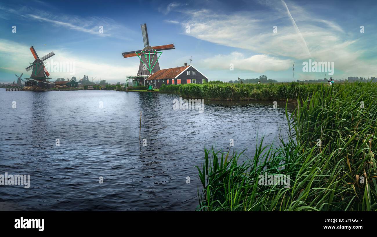 Traditional Dutch windmills along the canal at Zaanse Schans, Zaandam ...