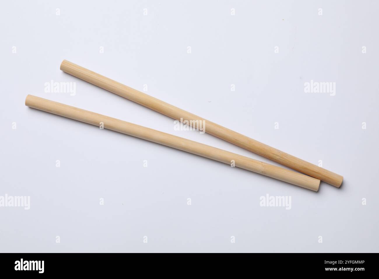Two bamboo drinking straws on white background Stock Photo - Alamy