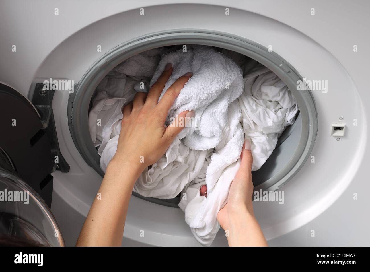 Woman taking clean clothes out of washing machine, closeup Stock Photo ...
