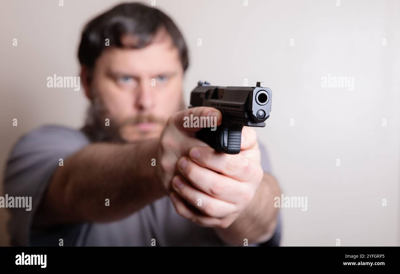 Man Aiming a Handgun with Intense Focus and Determination Stock Photo ...