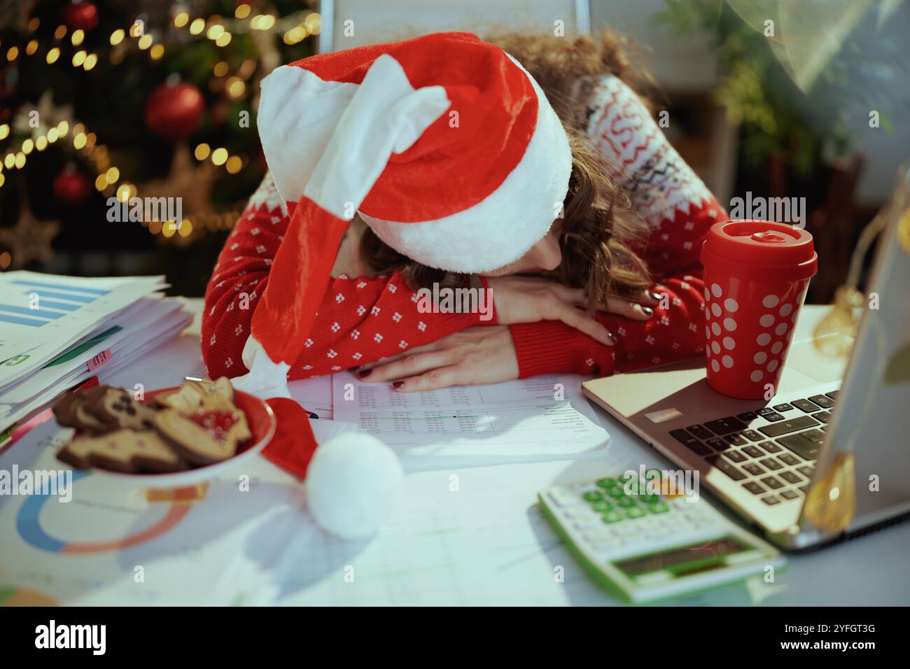 Christmas time. tired stylish middle aged business woman in santa hat ...