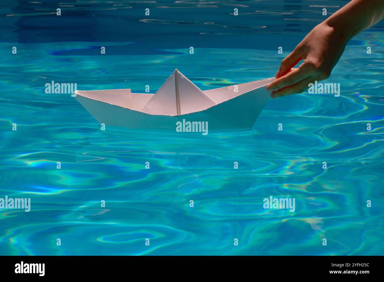 Paper ship in hand. Hand and paper boat Stock Photo - Alamy