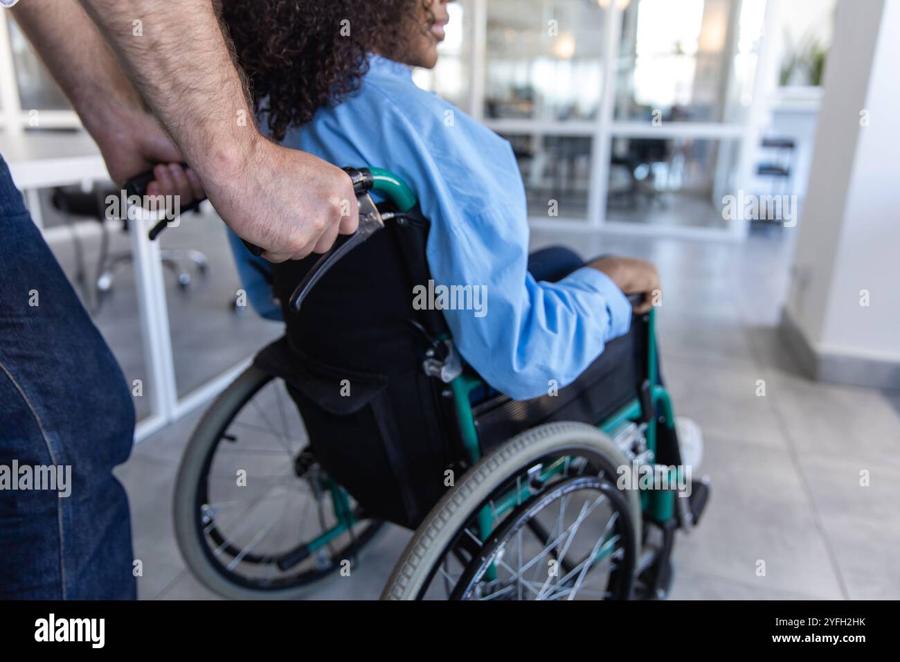 Disabled African American woman in wheelchair in modern office Stock ...