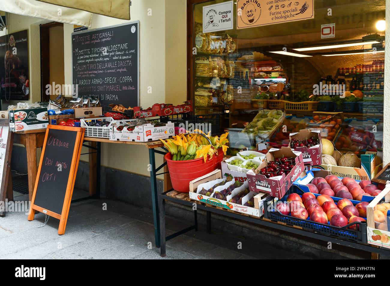 The exterior of a grocery store, featuring sidewalk stands brimming ...