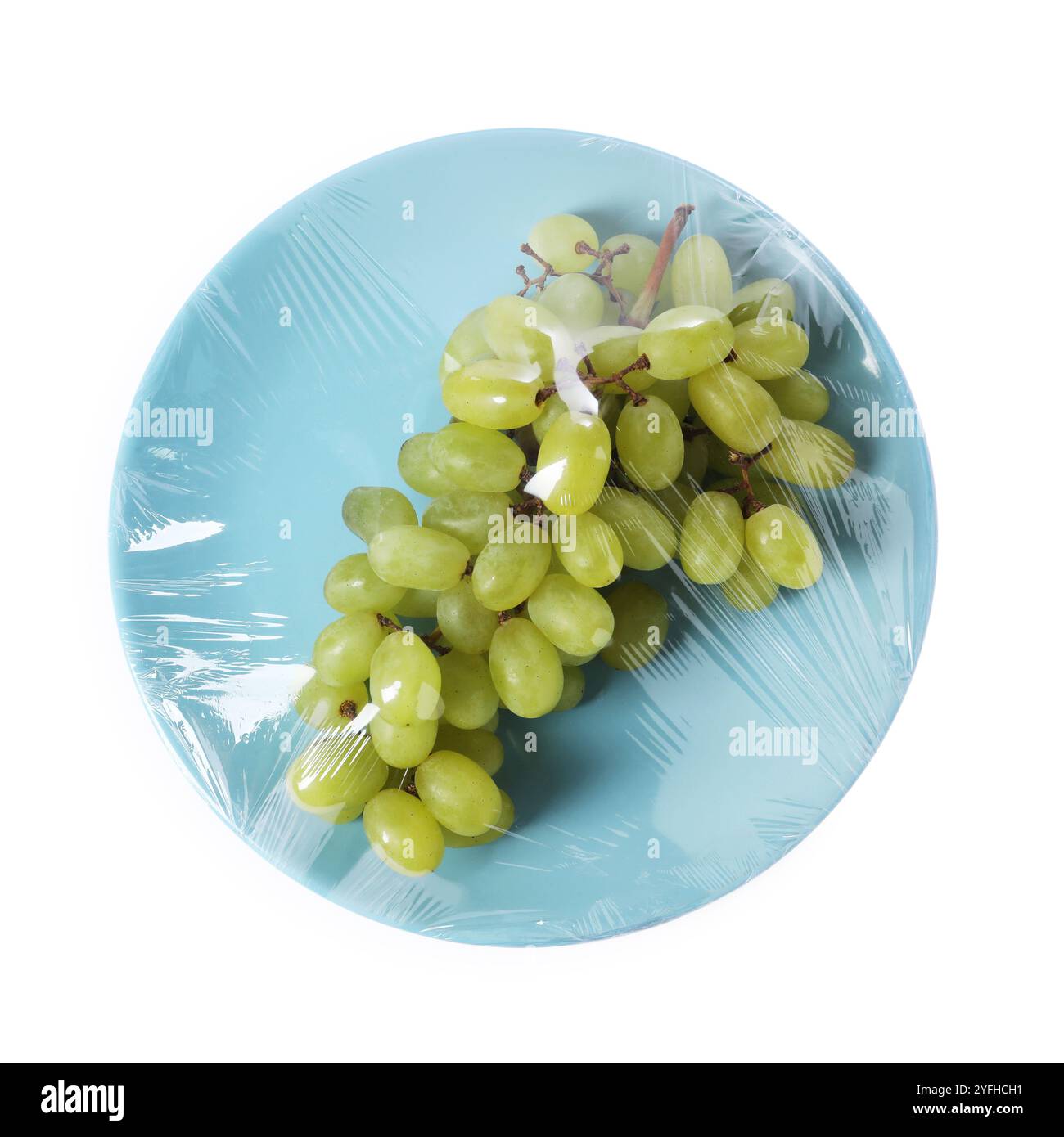 Plate of fresh grapes with plastic food wrap isolated on white, top ...