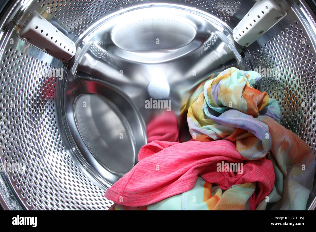 Washing machine with laundry as background, closeup Stock Photo - Alamy