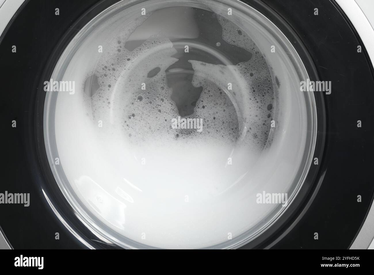 Washing machine with suds as background, closeup Stock Photo - Alamy