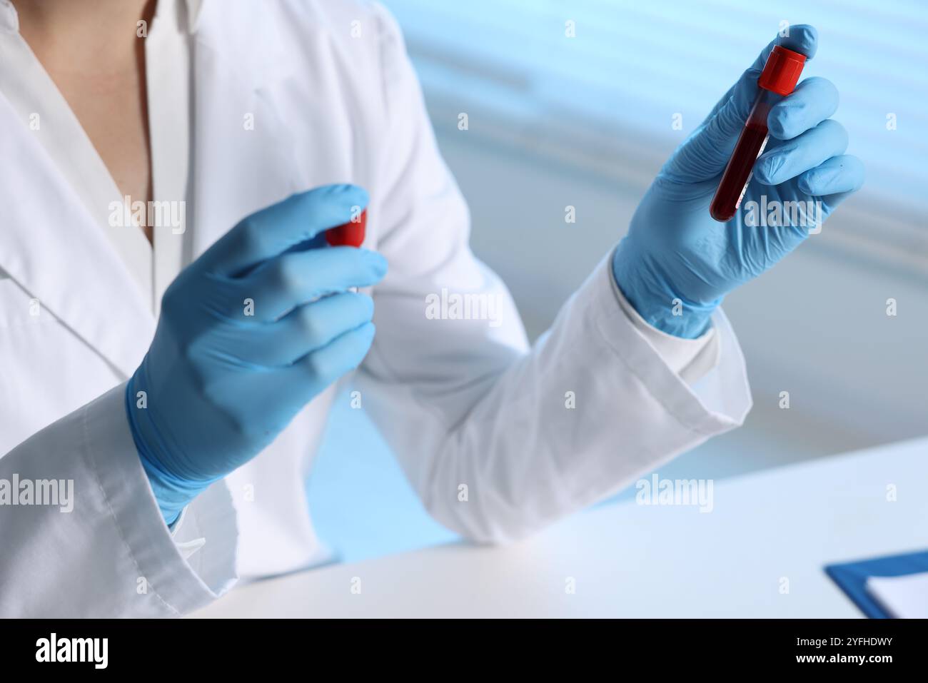 Laboratory testing. Doctor holding test tubes with blood samples at ...