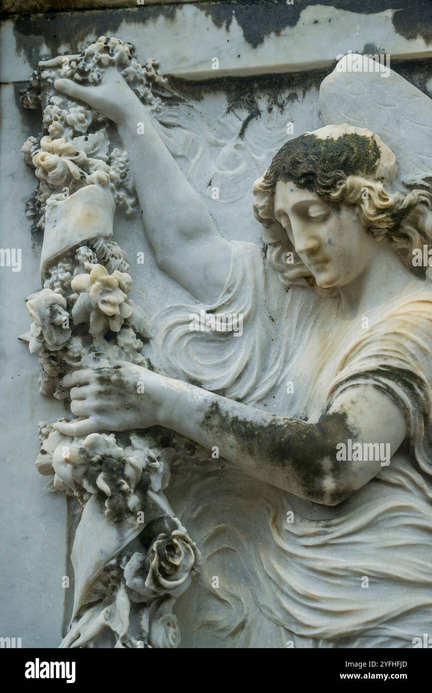 Elaborate stone carvings at a tomb of the cemetery next to the Church ...