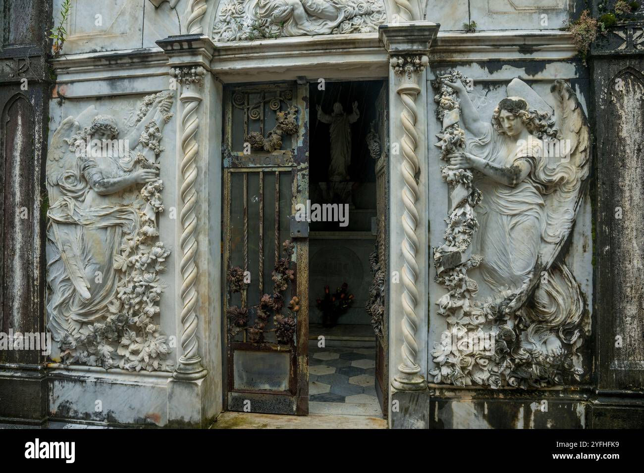 Elaborate stone carvings at a tomb of the cemetery next to the Church ...