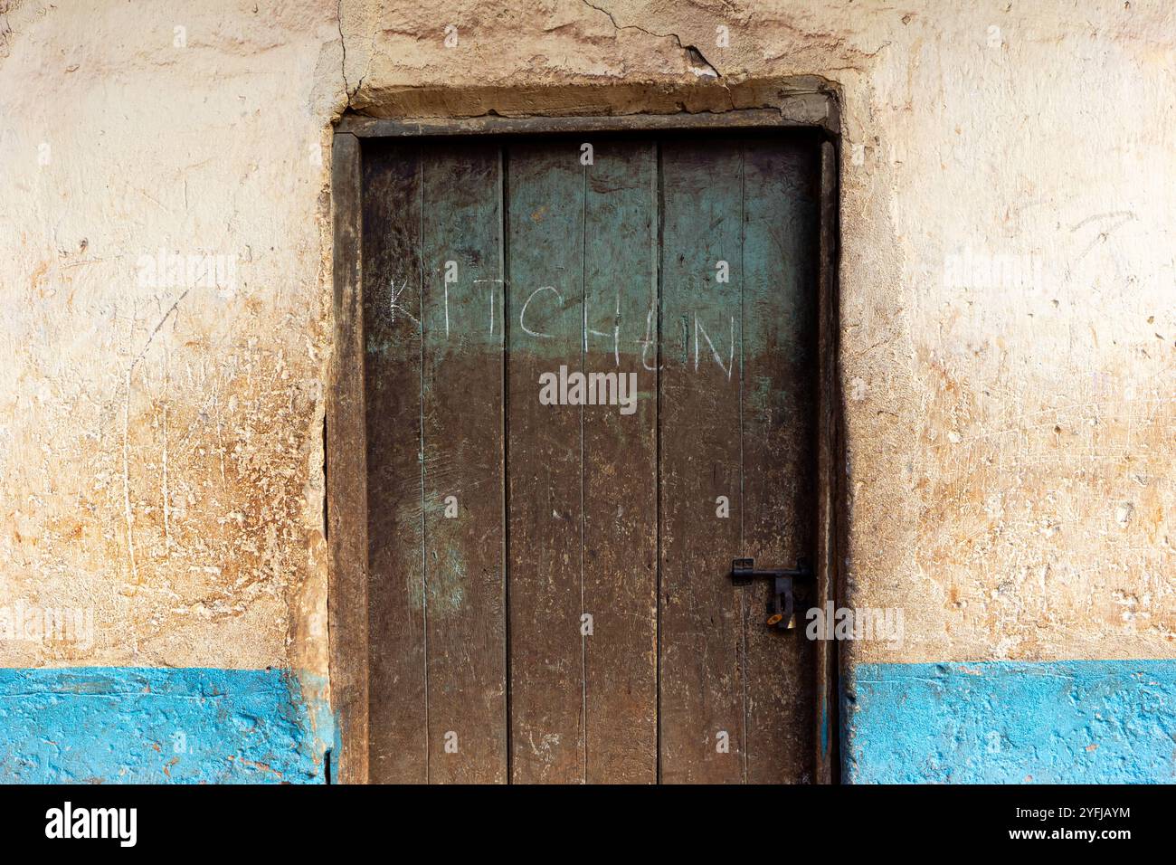 A wooden door at a Ugandan school with the inscription "kitchen" in ...