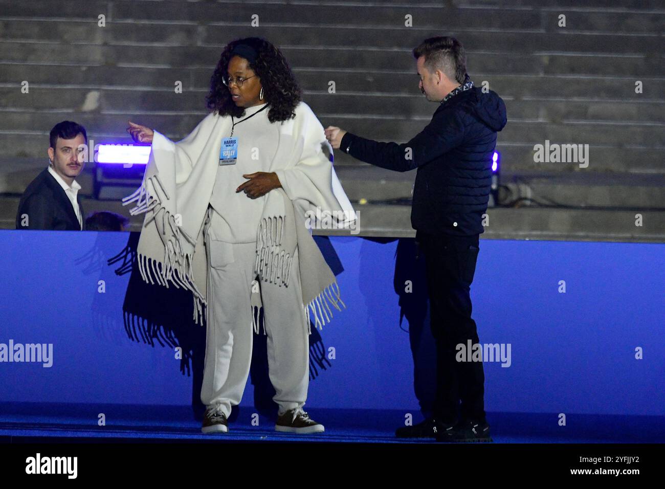Oprah Winfrey receives instructions on stage ahead of the Harris-Walz ...