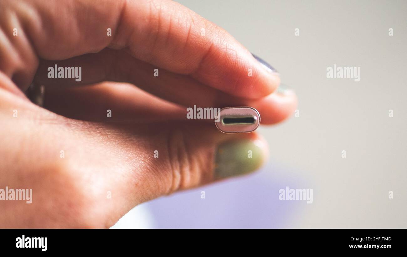A hand holding usb plug c type close up minimalist technology Stock ...