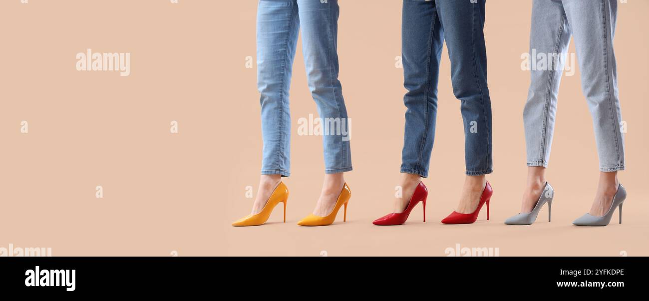 Legs of women in different high heels on beige background with space ...
