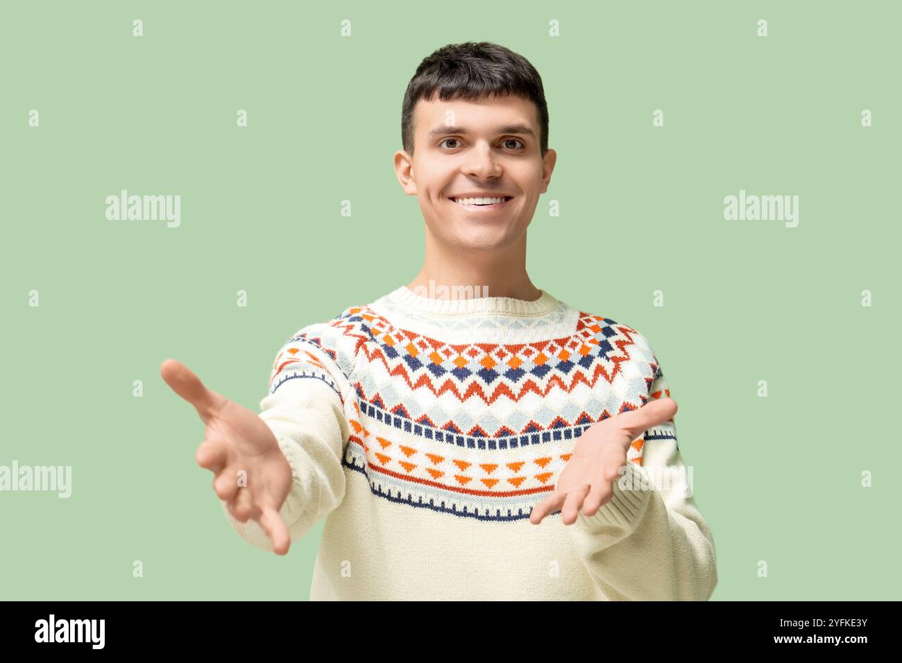 Young deaf mute man using sign language on green background Stock Photo - Alamy
