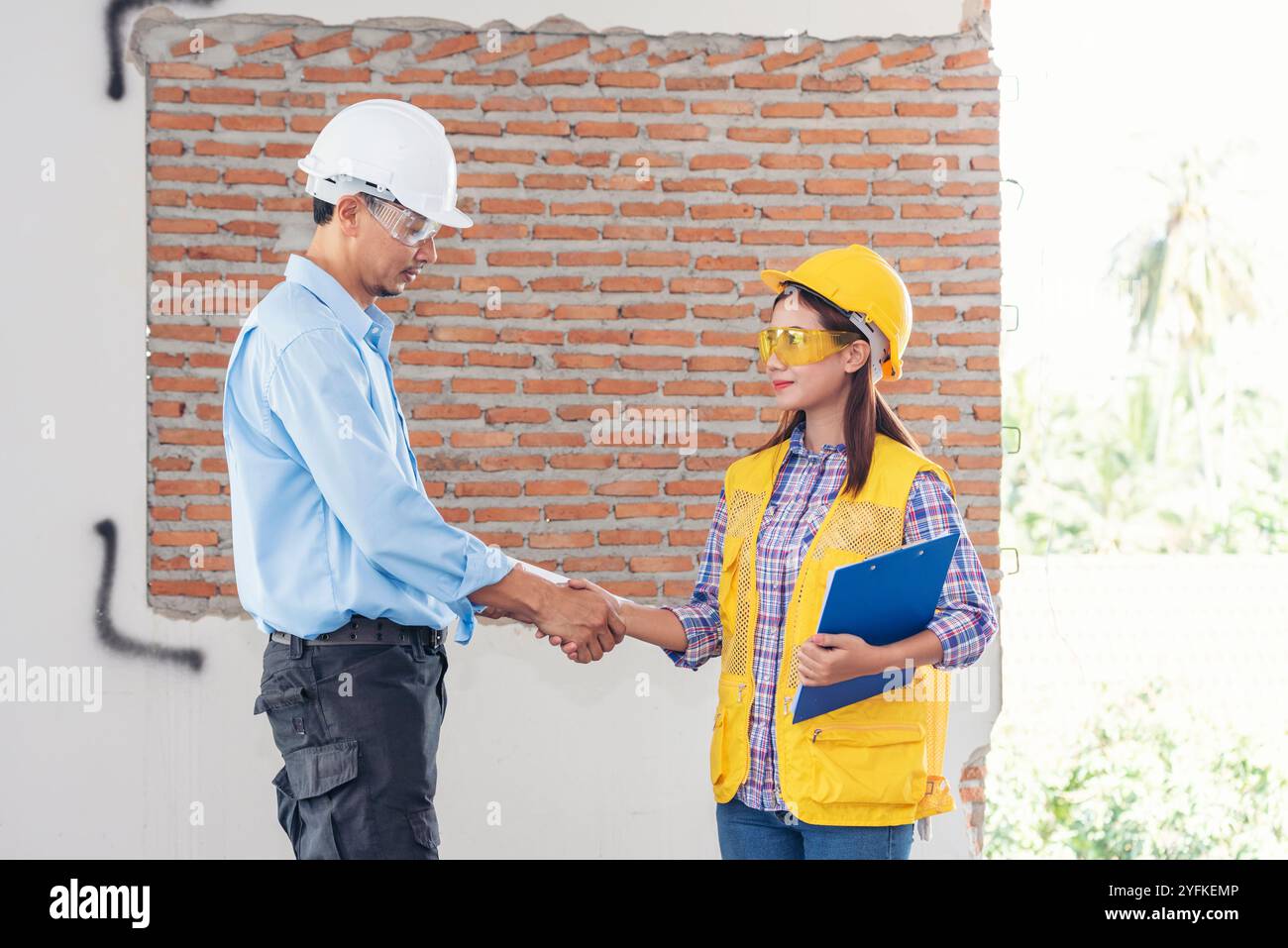 Civil Construction engineer teams shaking hands together wear work ...