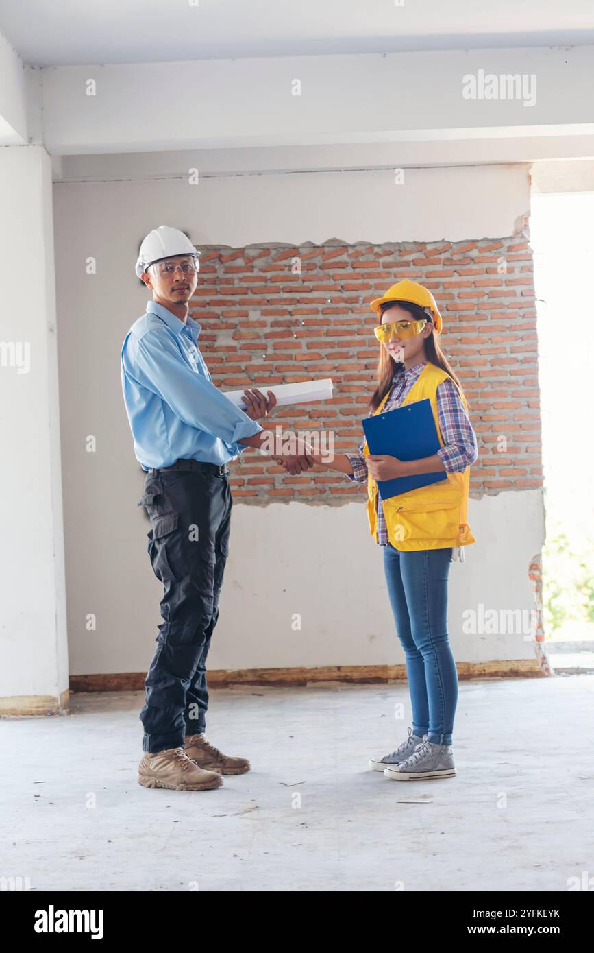 Civil Construction engineer teams shaking hands together wear work ...