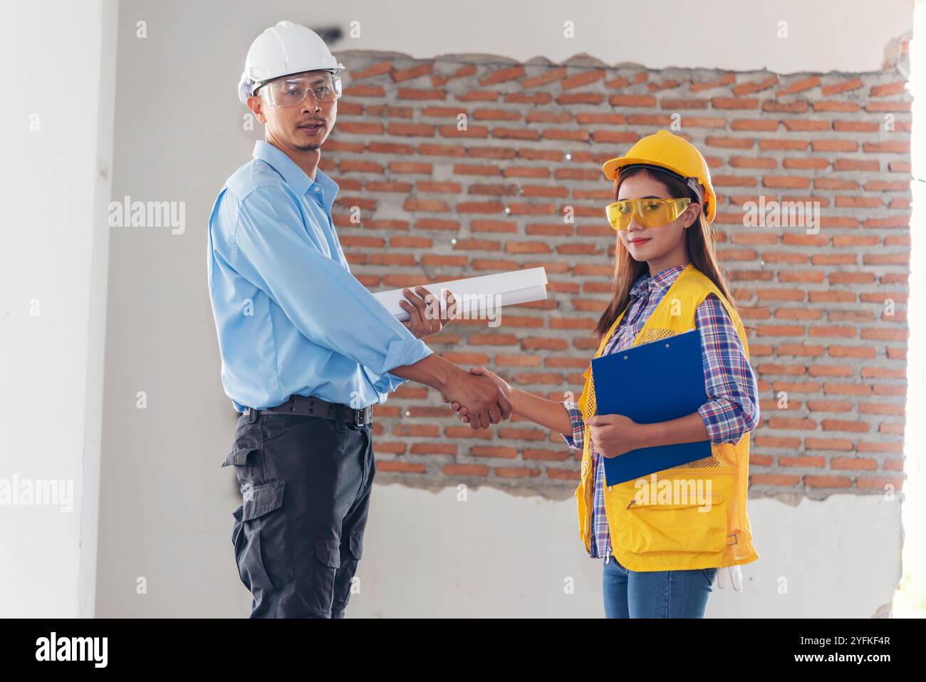 Civil Construction engineer teams shaking hands together wear work ...