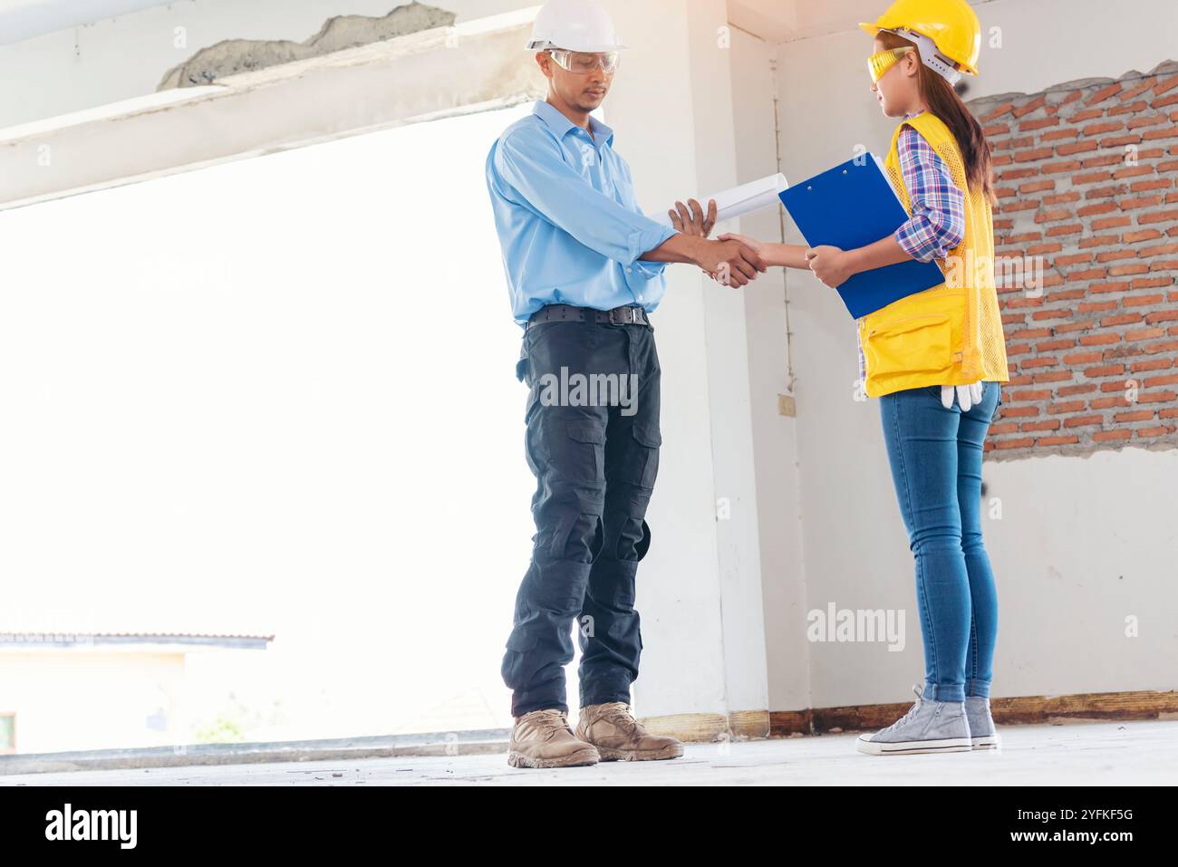 Civil Construction engineer teams shaking hands together wear work ...