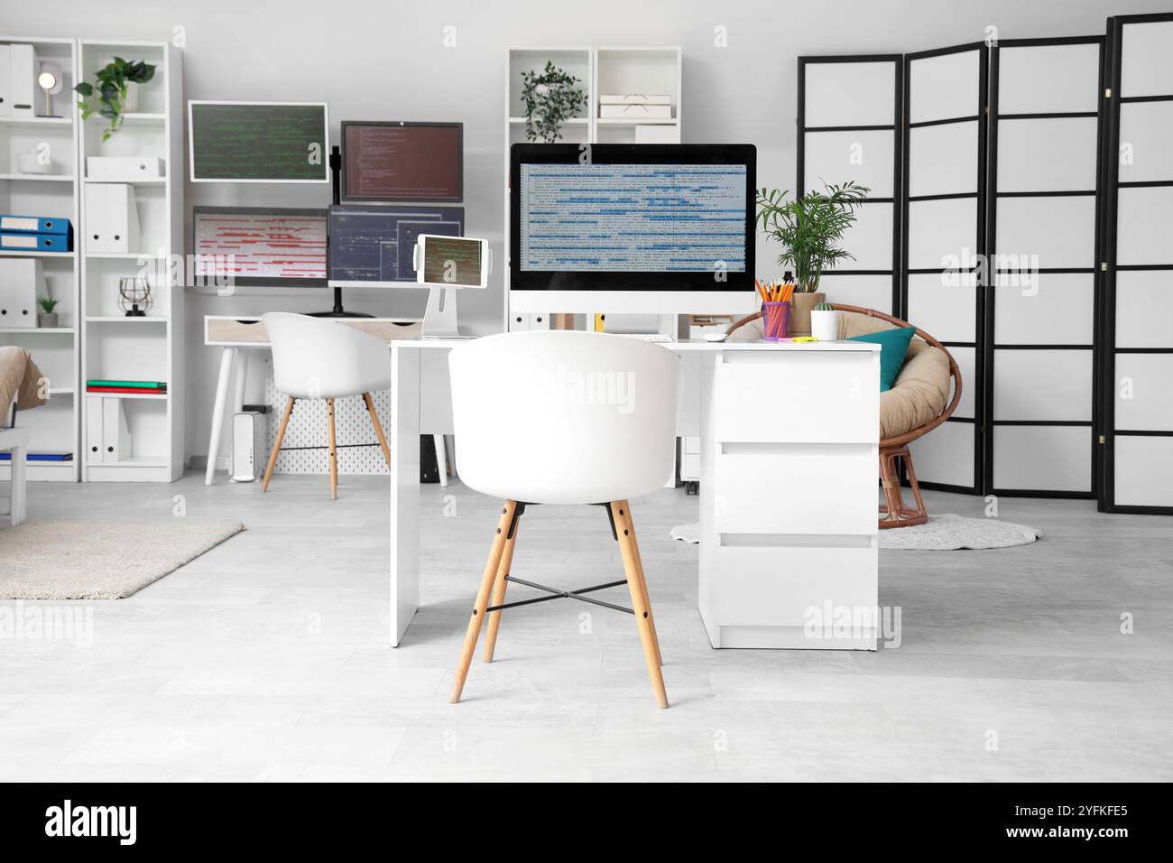 Interior of light programmer's office with desks, shelf units and ...