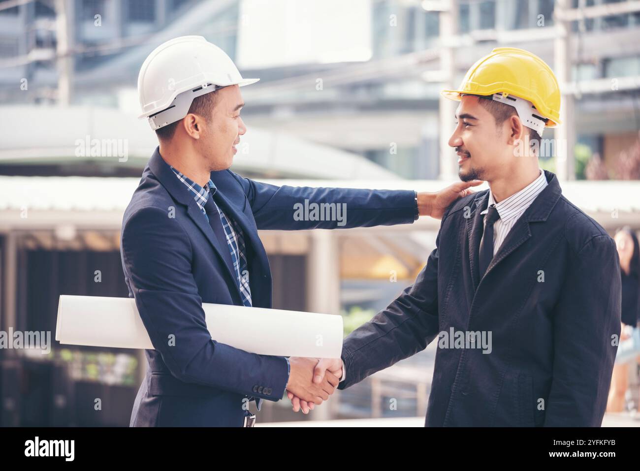 Civil Construction engineer teams shaking hands together wear work helmets worker on ...