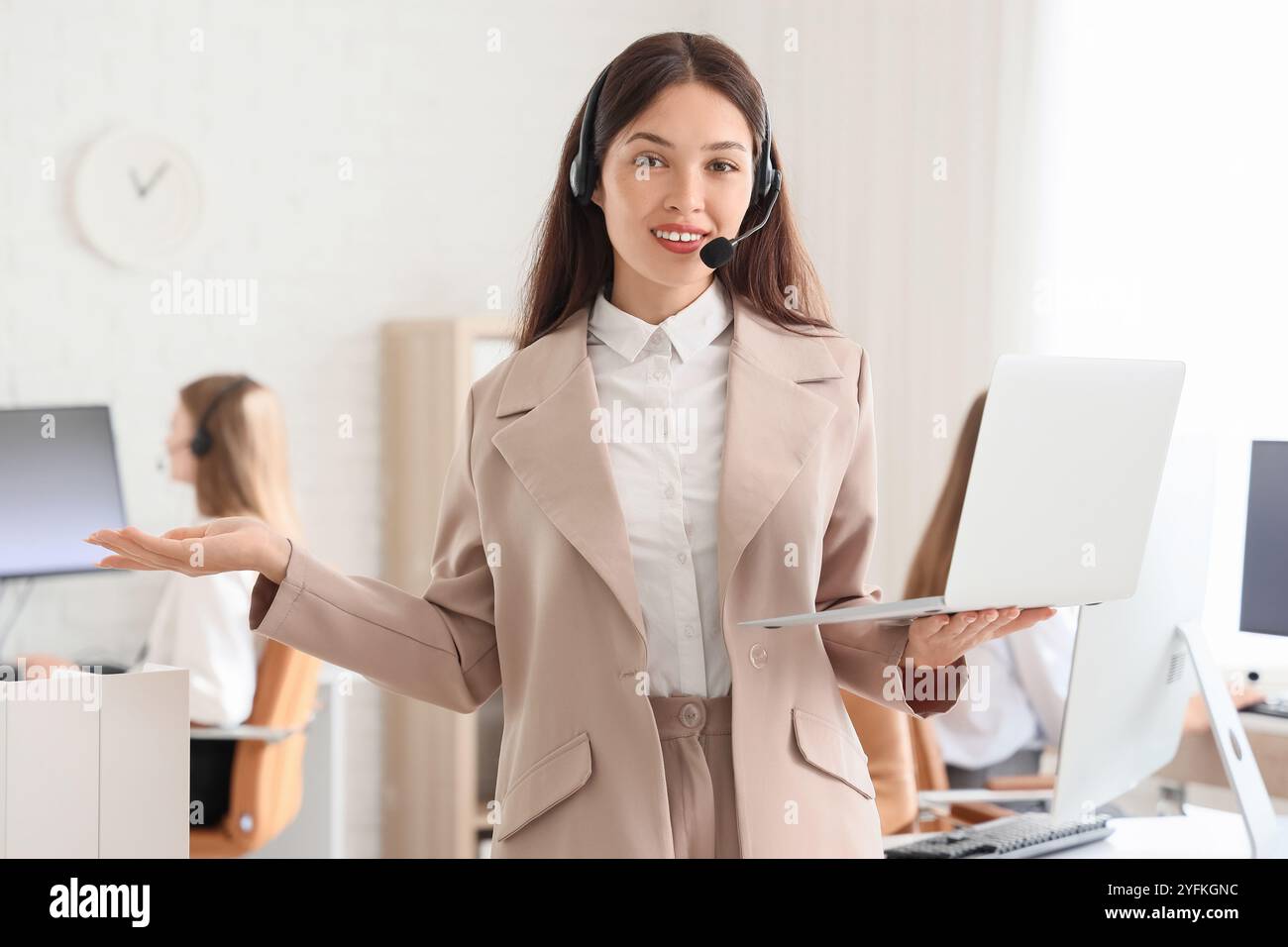 Female Asian technical support agent with laptop in office Stock Photo ...