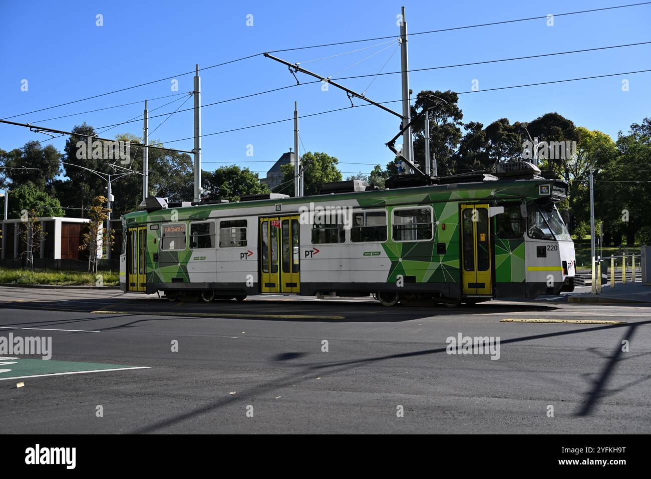 Side view of a Z-class tram, operated by Yarra Trams, as it pulls away ...