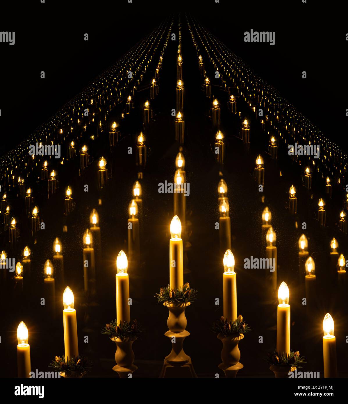 Candlesticks create a reflection in long rows in the window Stock Photo ...