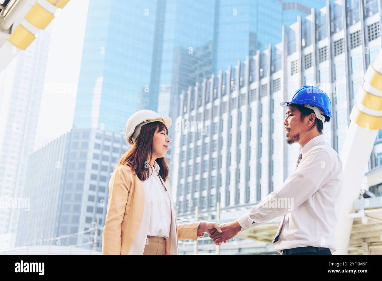 Civil Construction engineer teams shaking hands together wear work ...