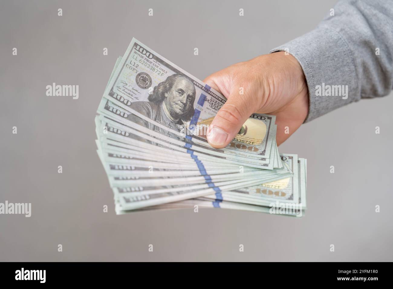 A Person Counting US Dollar Bills. Close up of someone hands holding ...