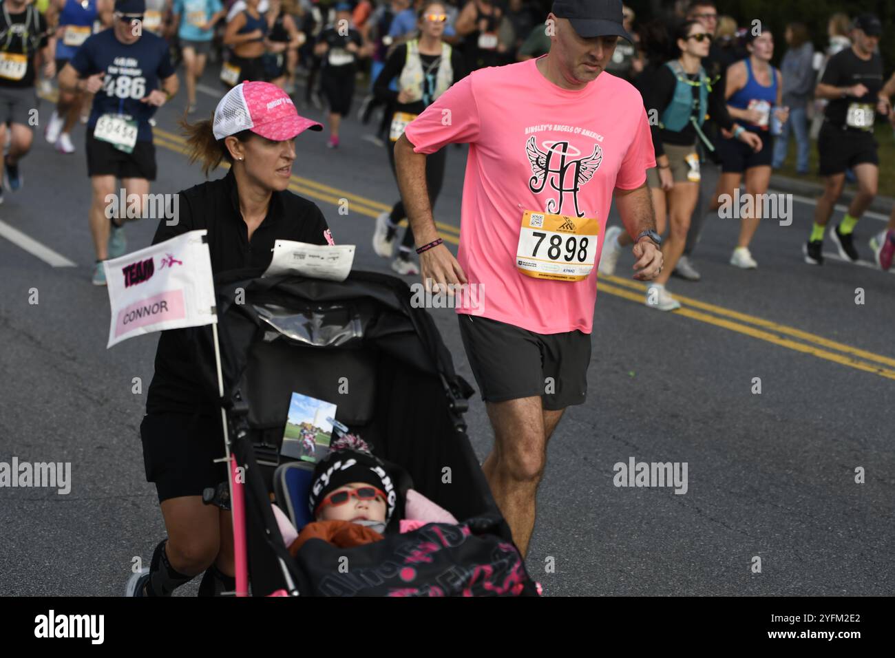 Male running pushing disabled person in a Wheelchair bike pink color ...