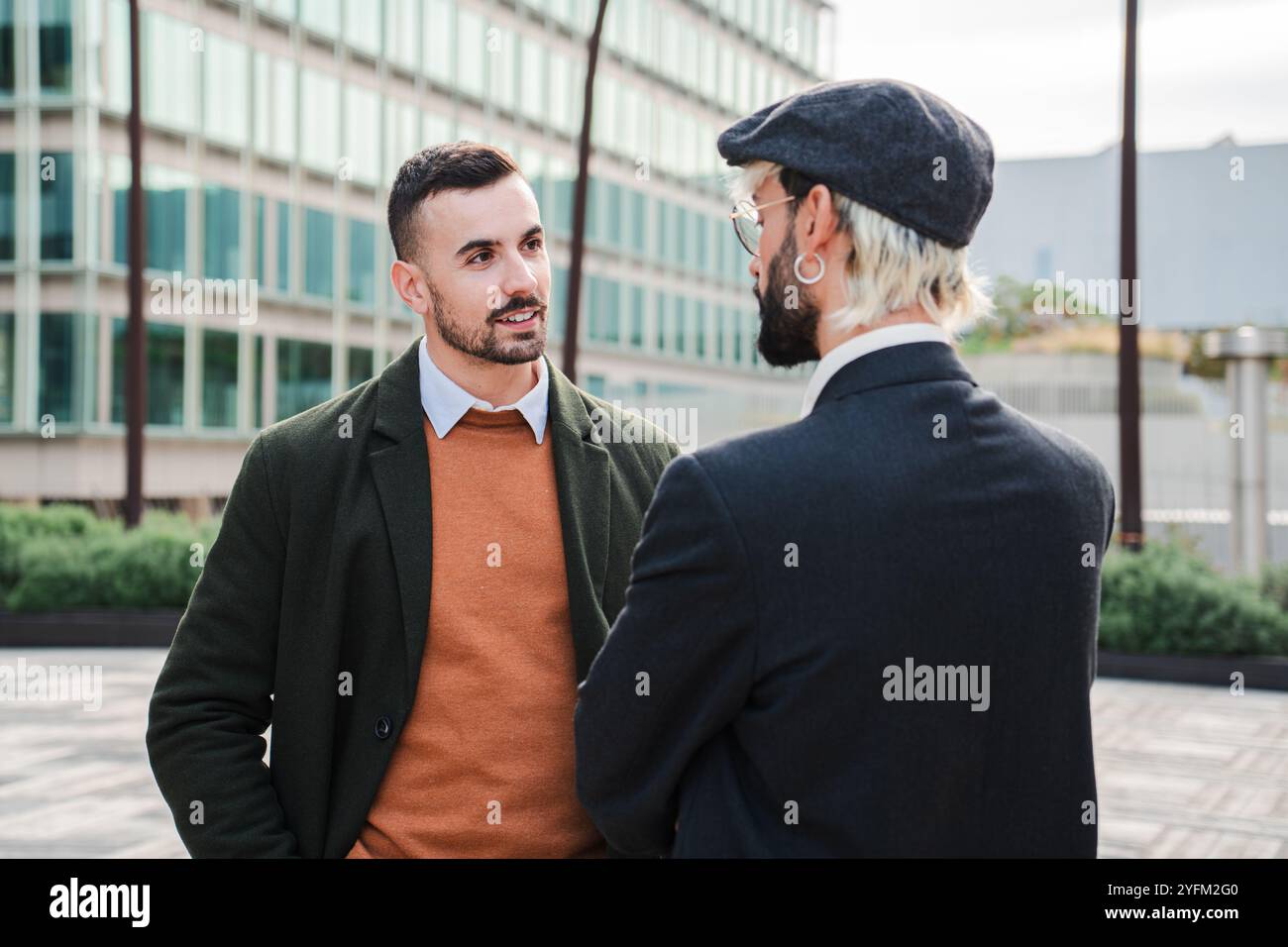 Two colleagues engage in conversation hi-res stock photography and ...