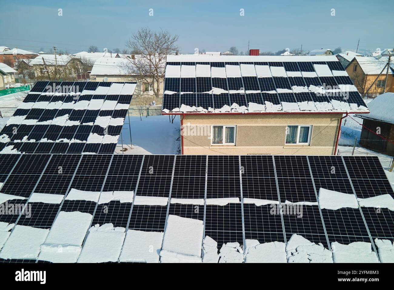 Aerial view of snow melting from covered solar photovoltaic panels ...