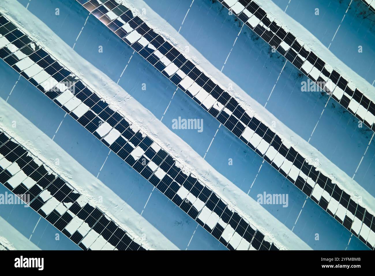 Aerial view of snow melting from covered solar photovoltaic panels at ...