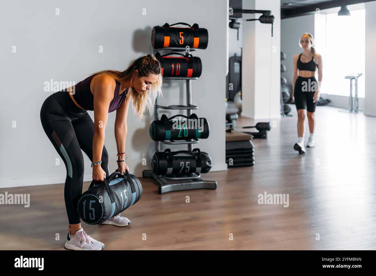 Woman lifting heavy bag hi-res stock photography and images - Alamy