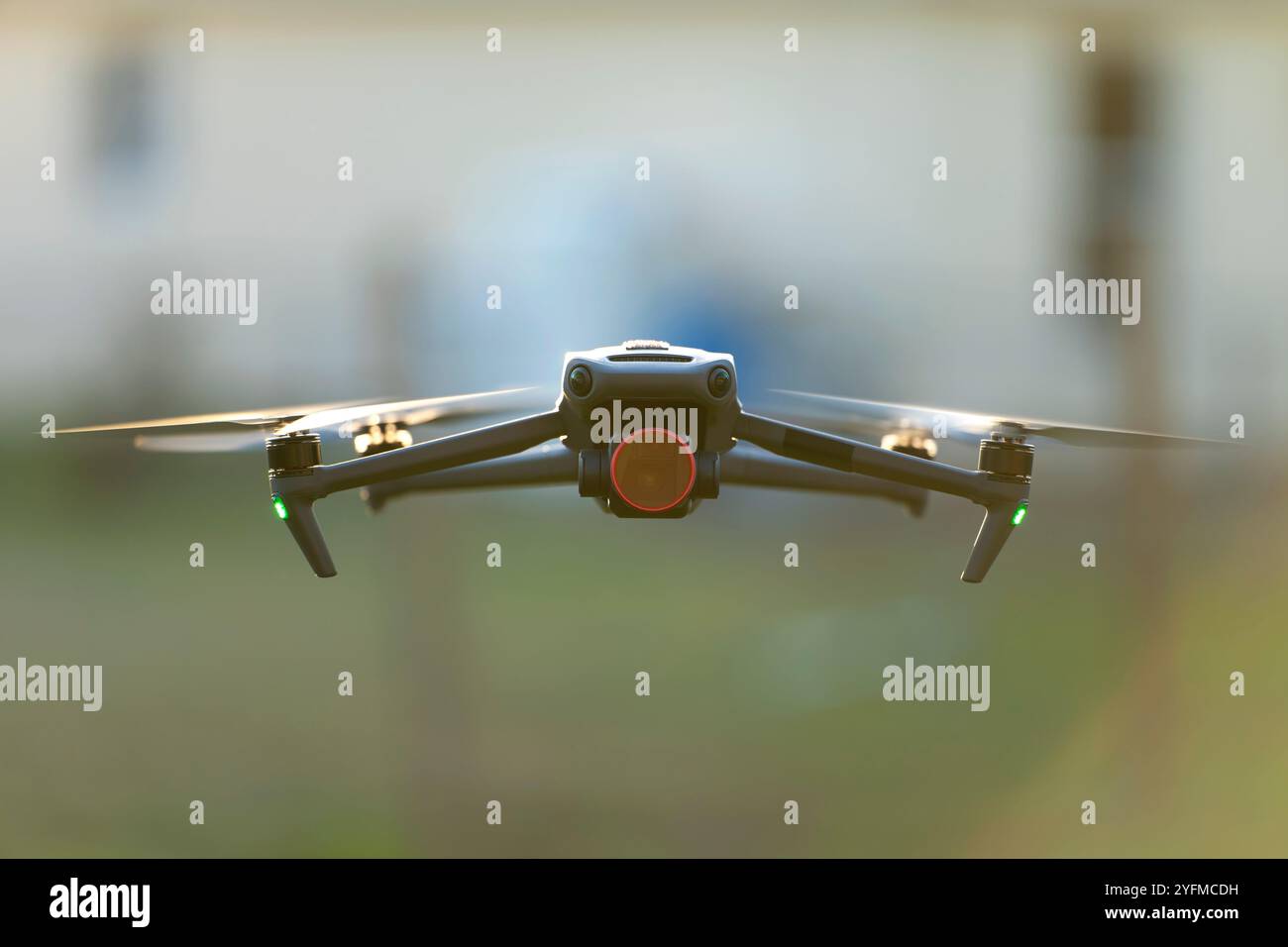 Drone aircraft with blurred fast rotating propellers and video camera ...