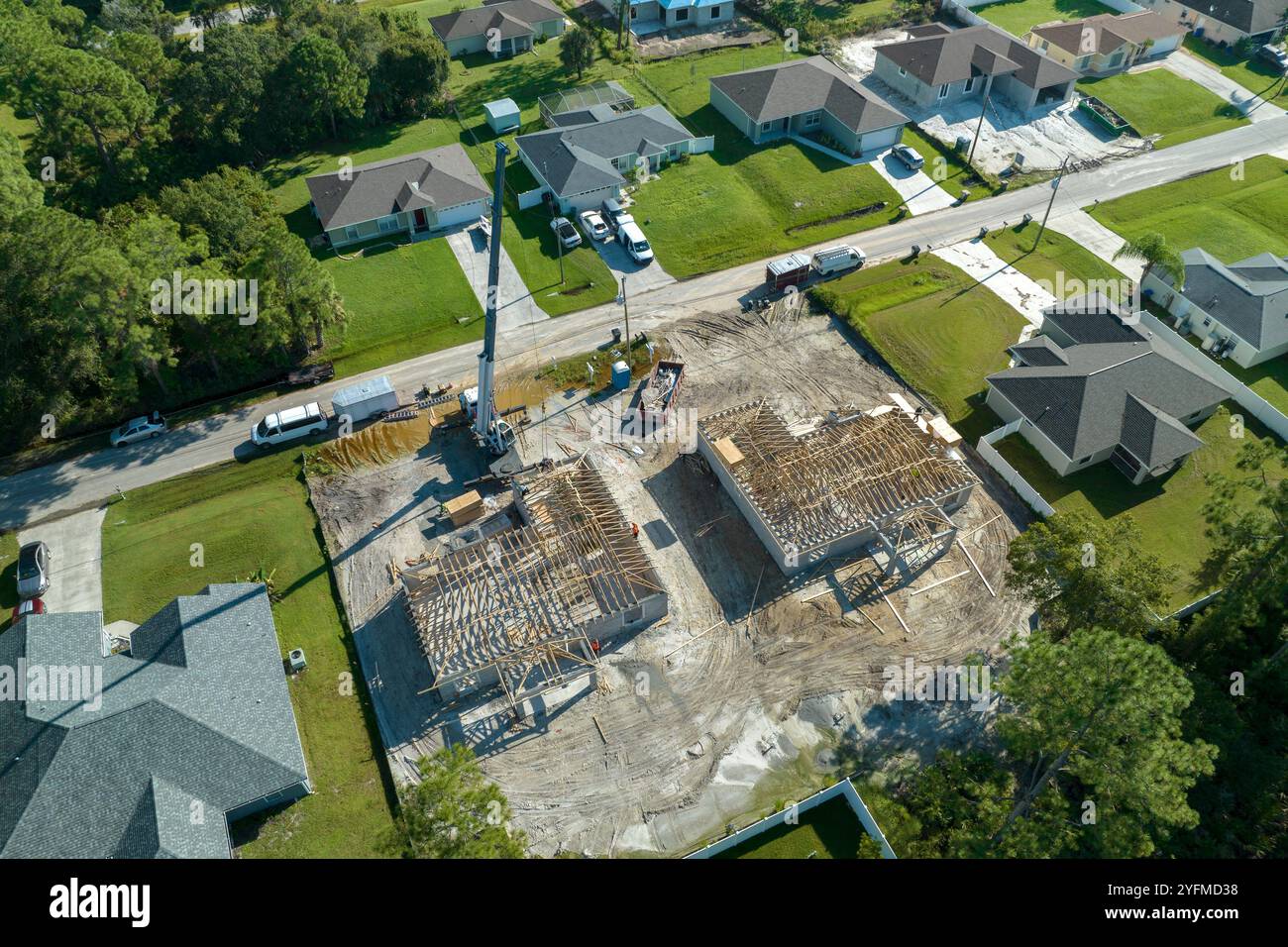 Aerial view of lifting crane and builders working on unfinished ...