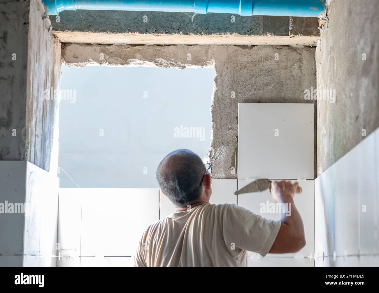 Installing new tiles hi-res stock photography and images - Alamy
