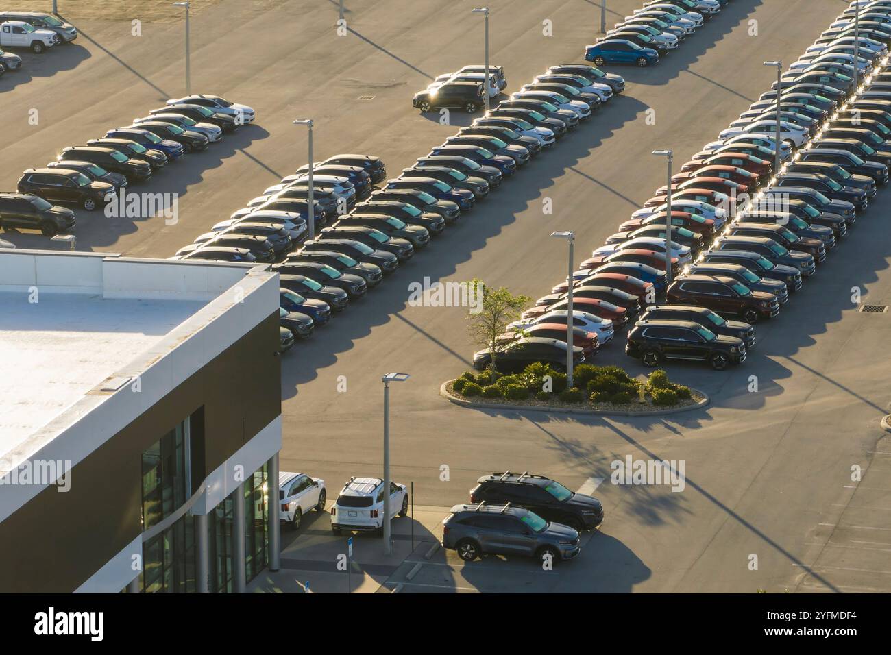 Aerial view of dealership parking lot with many brand new cars for sale ...