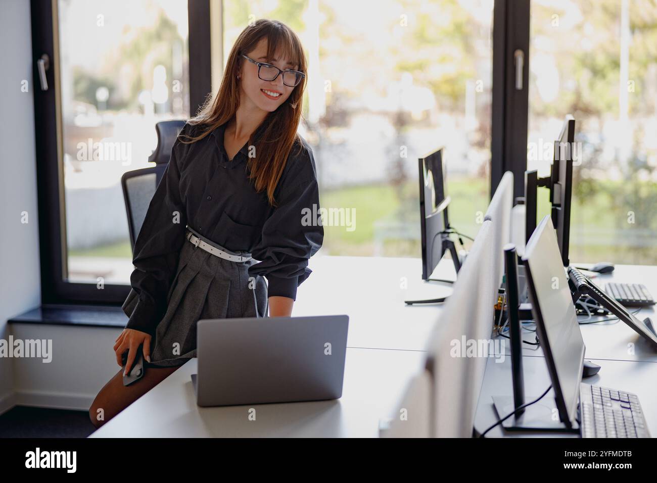 A Professional Woman Working in a Modern Office Environment with ...